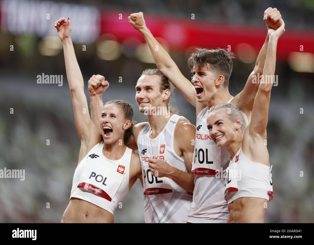 Members of Poland's 4x400-meter mixed relay team celebrate after ...
