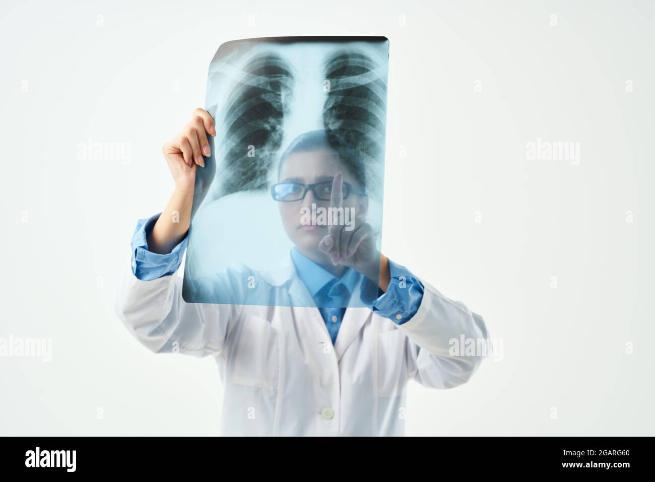 female doctor holding an x-ray in front of her hospital treatment ...