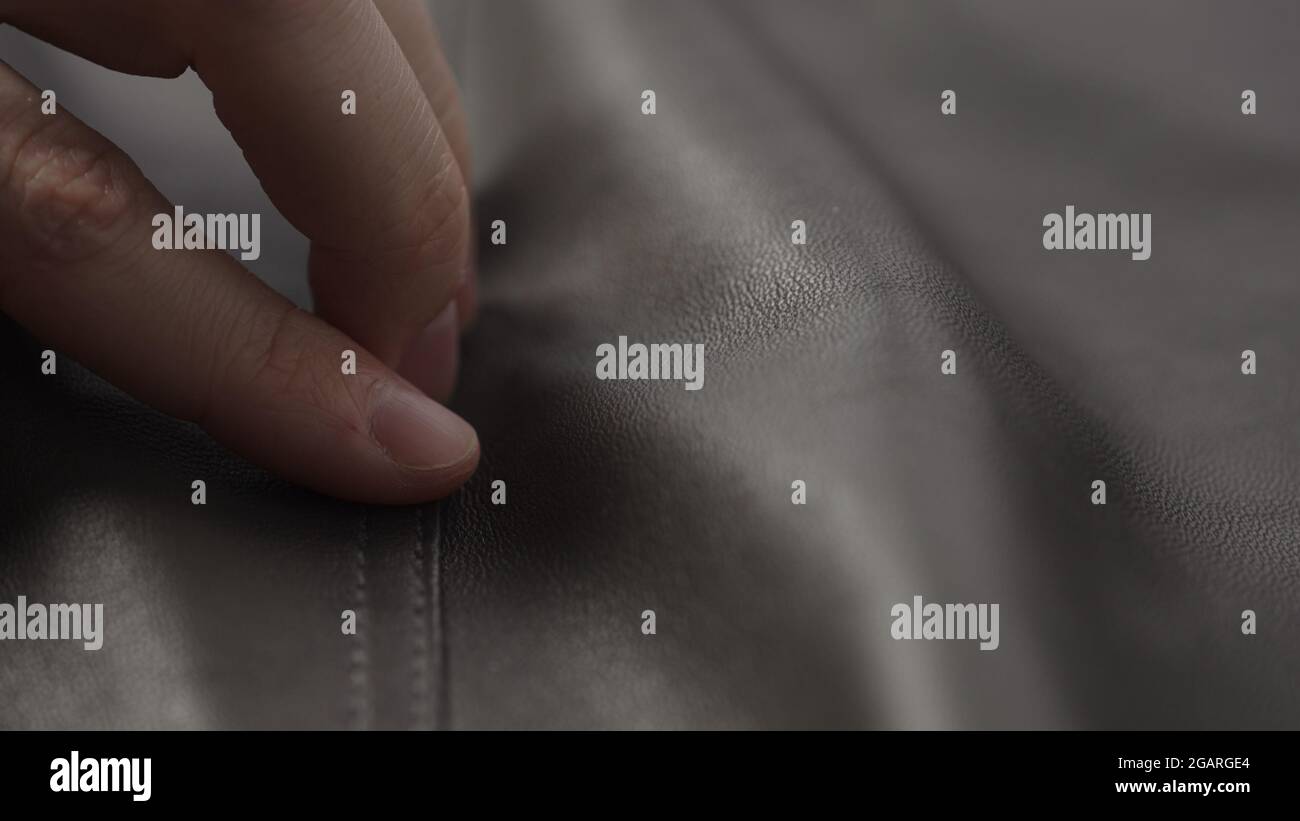 Closeup man touching fine leather, wide photo Stock Photo - Alamy