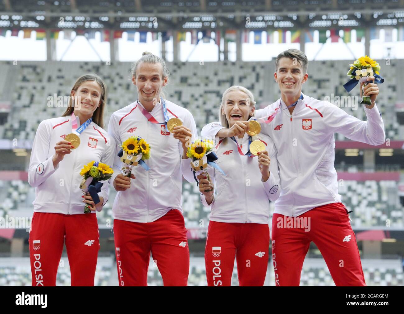 Members of Poland's 4x400-meter mixed relay team pose with their gold ...