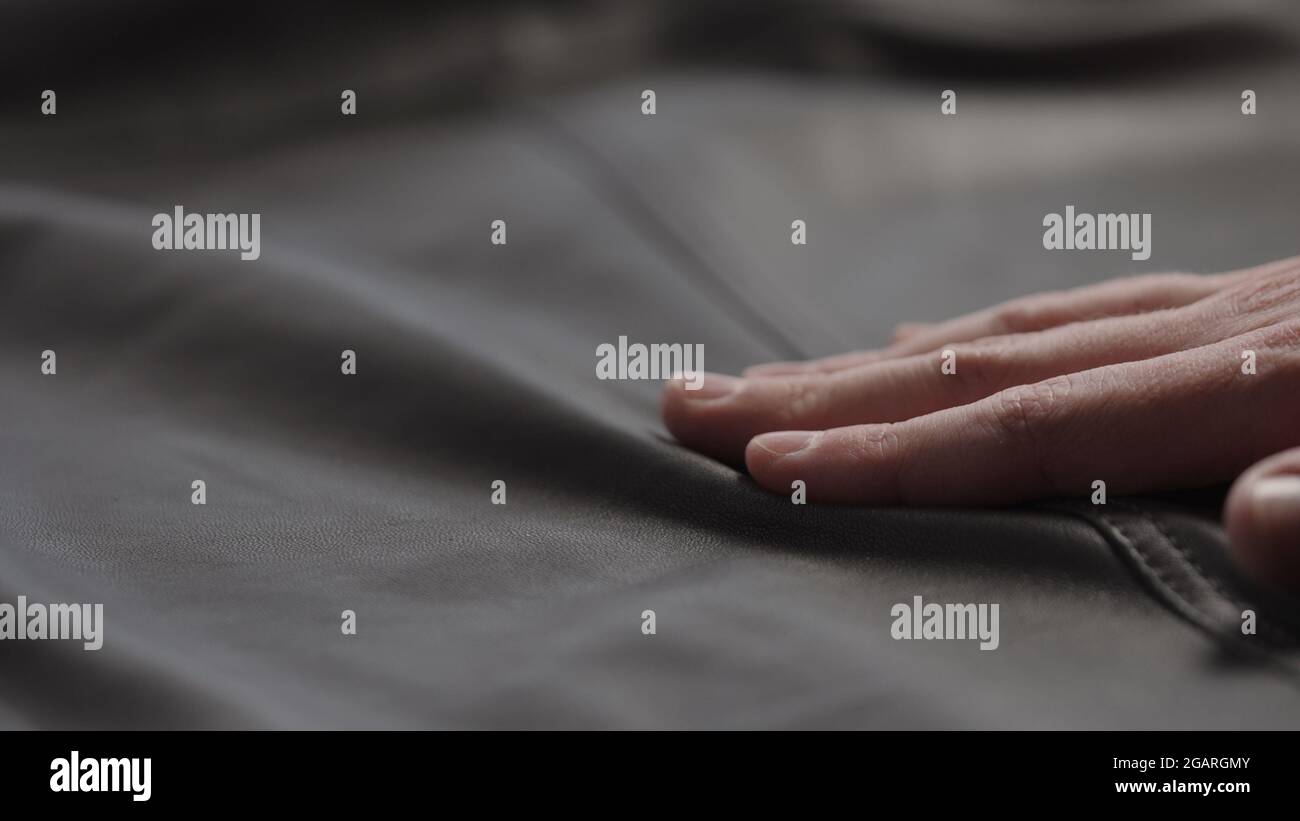 Closeup man touching fine leather, wide photo Stock Photo - Alamy