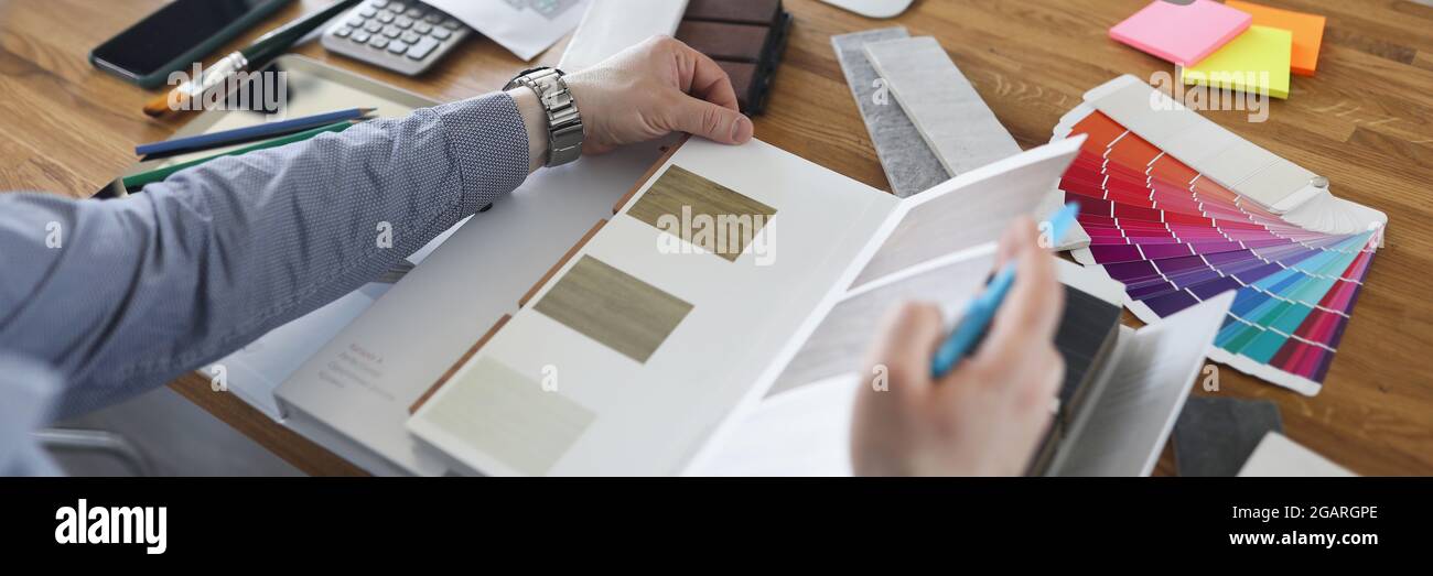 Male designer chooses flooring pattern for home closeup Stock Photo - Alamy