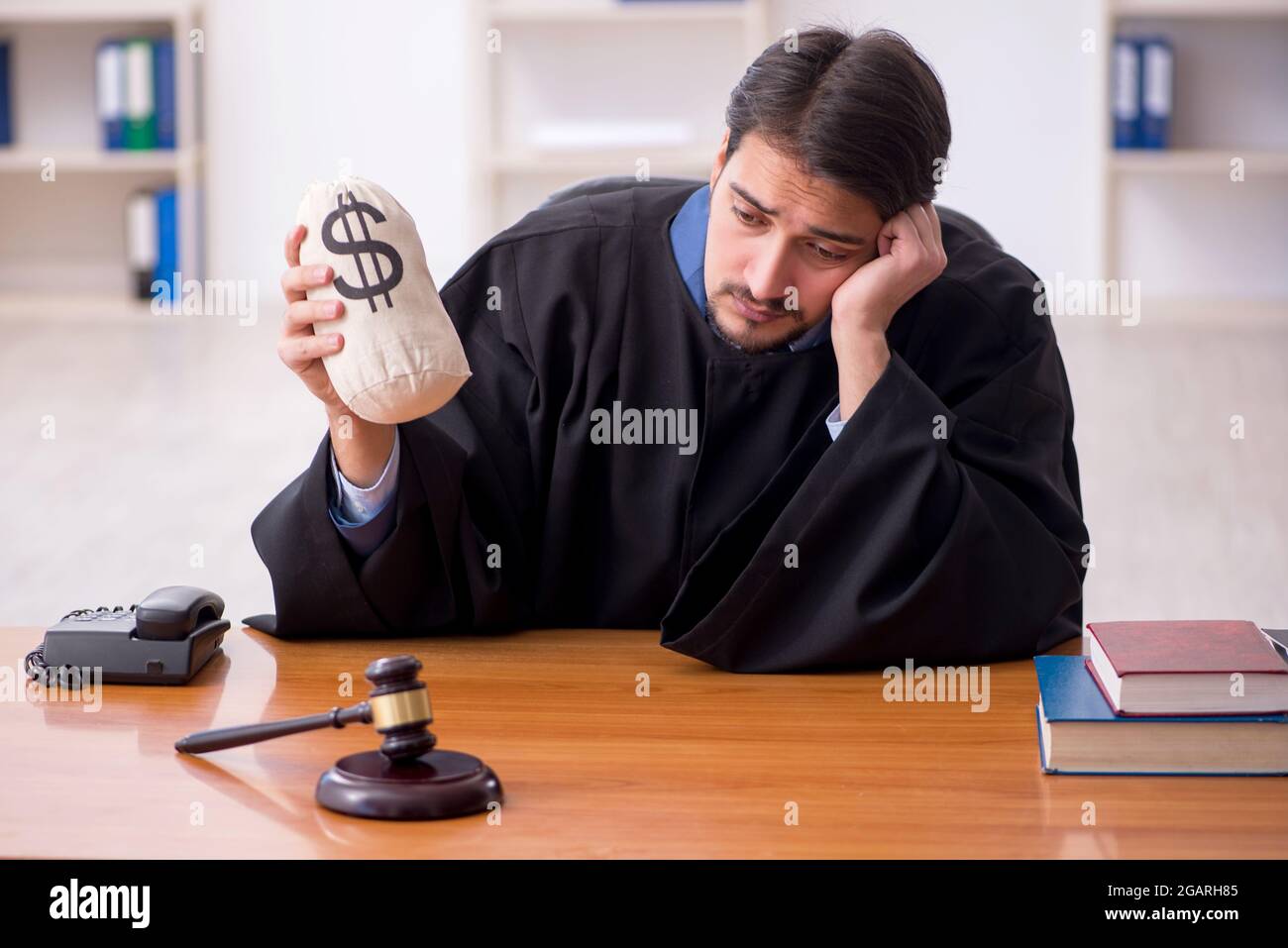 Young judge working in the courtroom Stock Photo - Alamy
