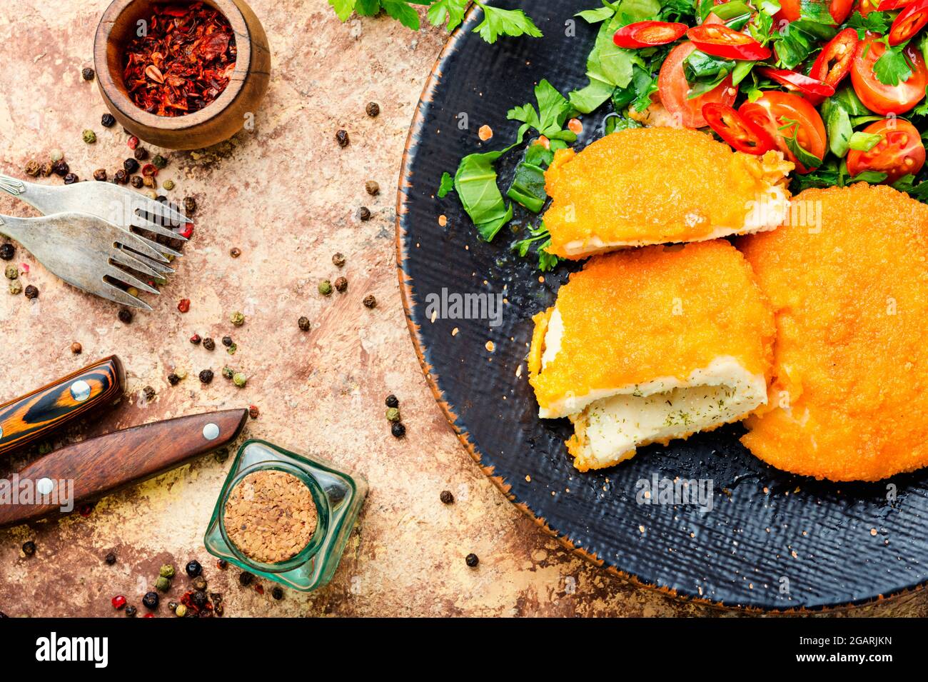 Homemade Kiev cutlet with spring vegetable salad Stock Photo - Alamy