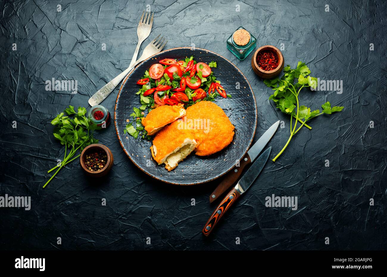 Homemade Kiev cutlet with spring vegetable salad Stock Photo - Alamy