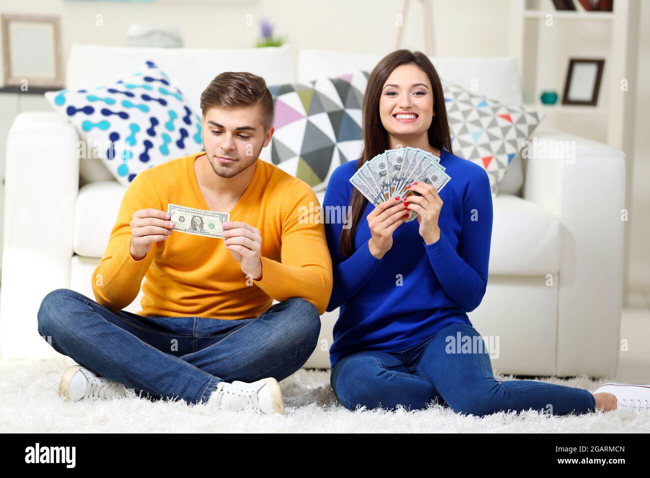 Happy couple in a room with money Stock Photo - Alamy