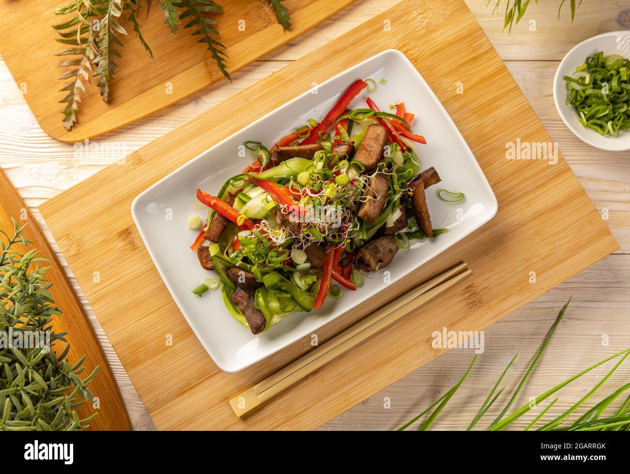 Flat lay of Asian style salad with beef cubes decorated with sprouts ...