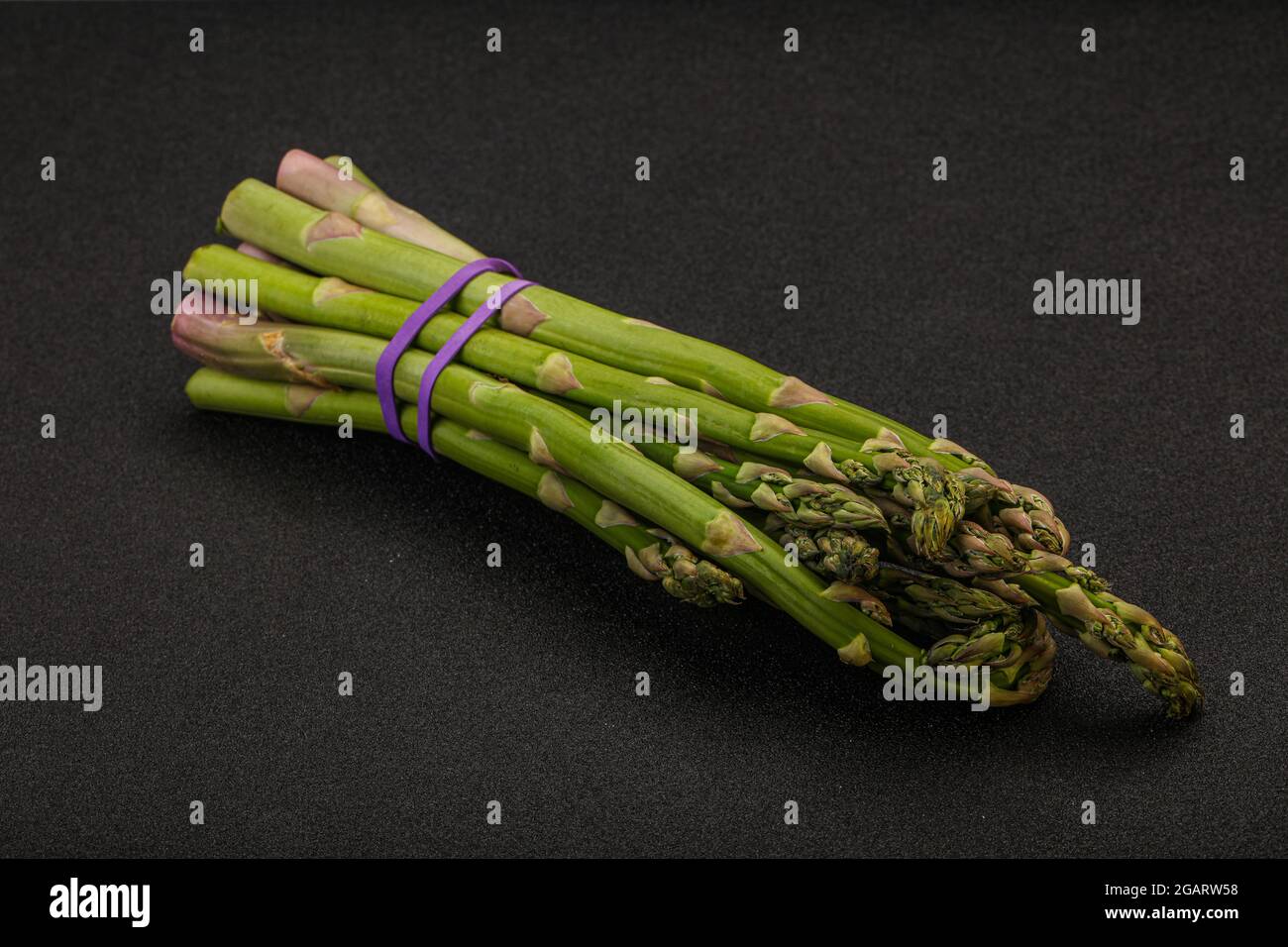 Vegan cuisine - Raw asparagus heap for cooking Stock Photo - Alamy