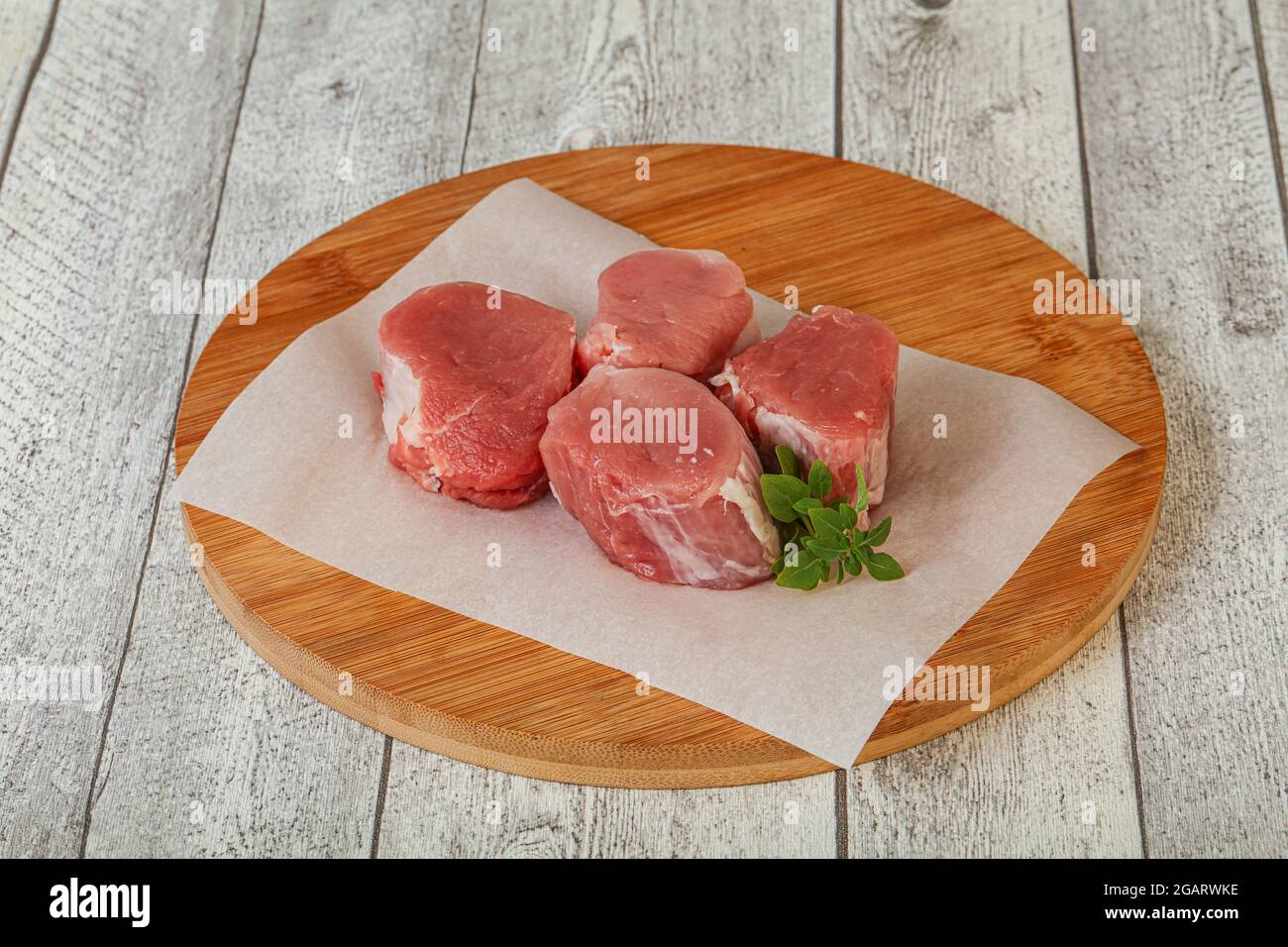 Raw pork medallion served rosemary for cooking Stock Photo - Alamy