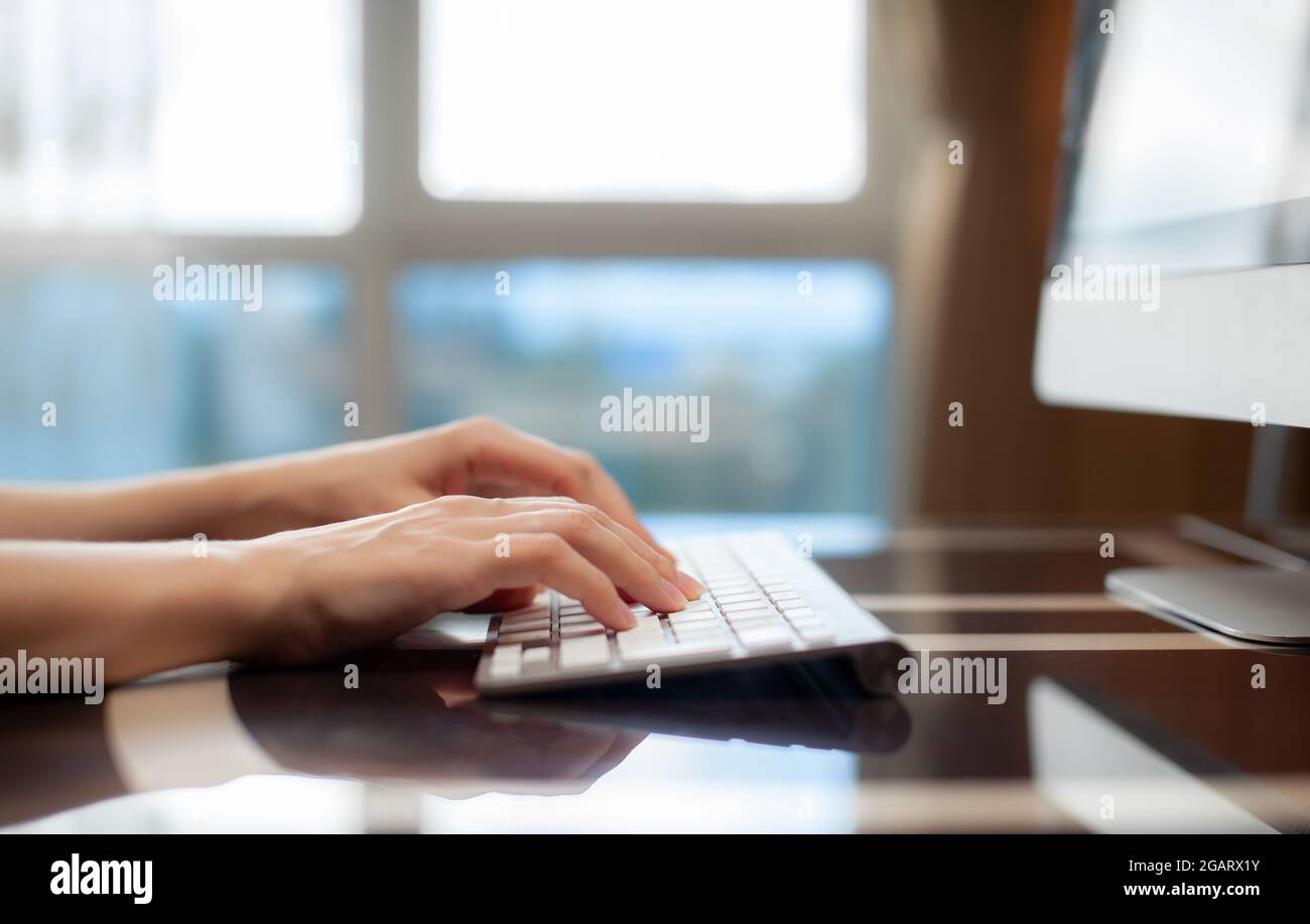 Female hands typing text on the keyboard while exchanging messages with ...