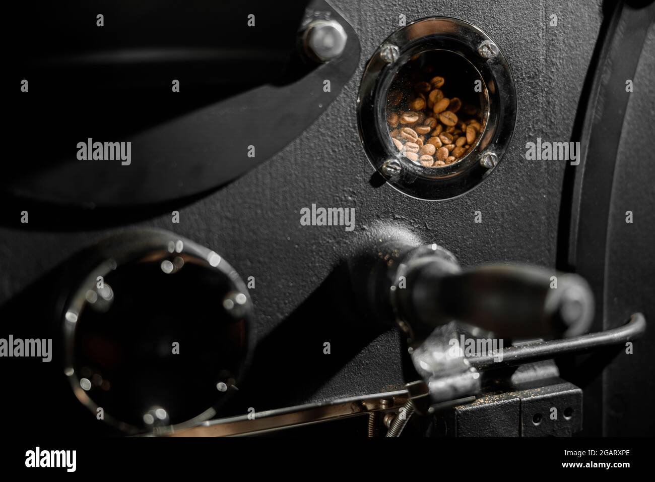 Coffee processing. Roastery, roasting machine and fresh beans Stock ...