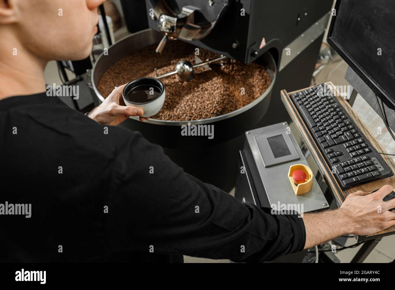 Coffee processing. Roastery, roasting machine and fresh beans Stock ...