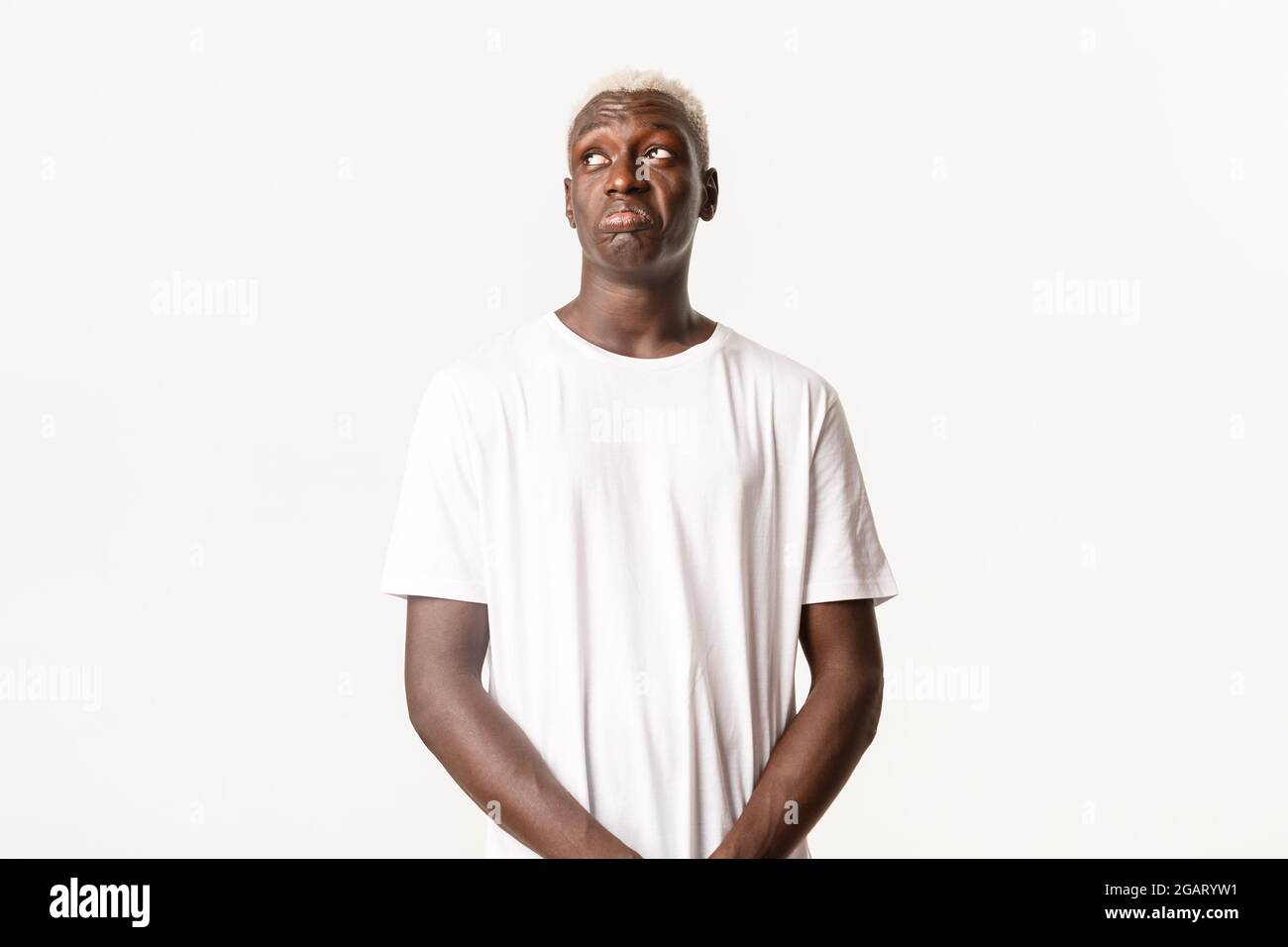 Portrait of thoughtful african-american blond guy looking upper left ...