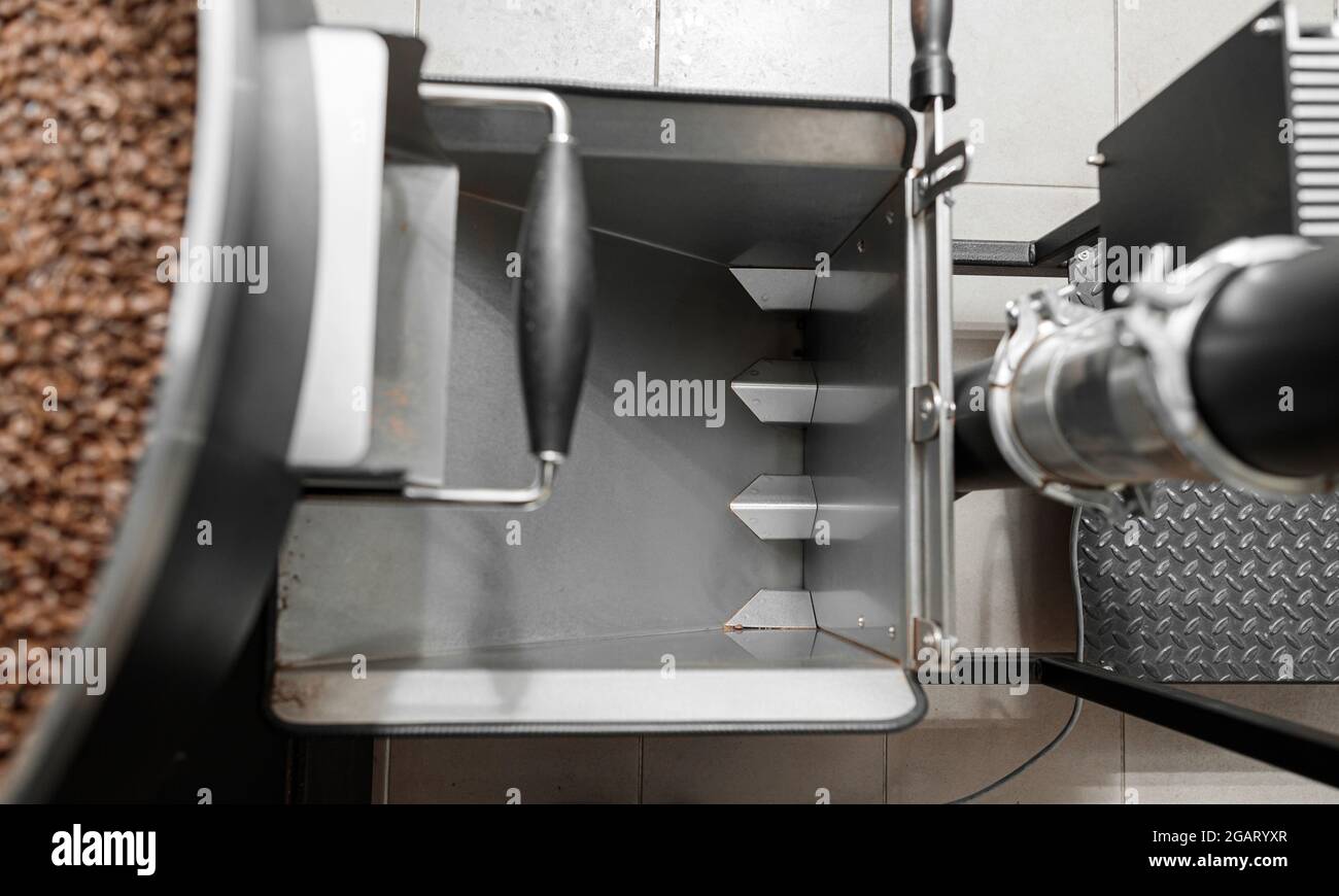 Coffee processing. Roastery, roasting machine and fresh beans Stock ...