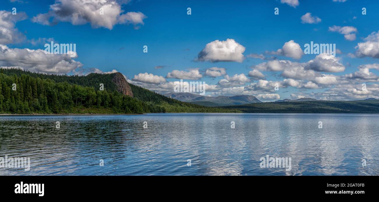 A picturesque panorama lake landscape with forest on the lakeshore and ...