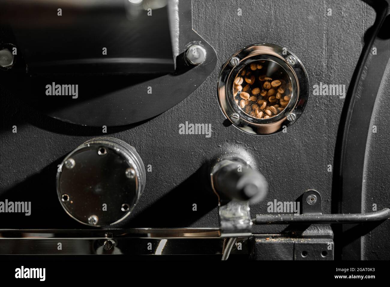 Coffee processing. Roastery, roasting machine and fresh beans Stock ...