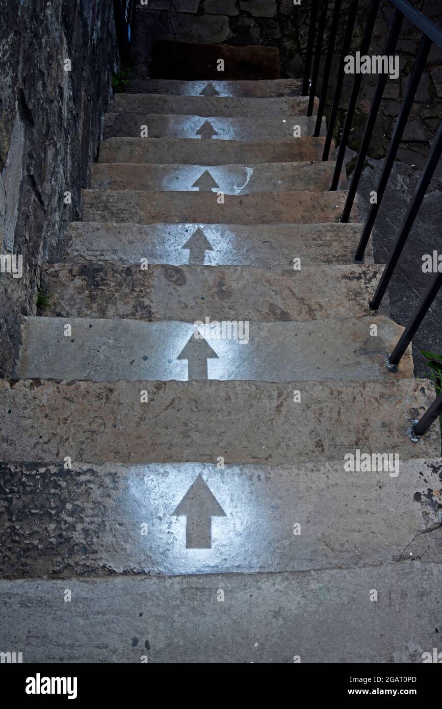 Stencilled arrows pointing down steps to a basement in the New Town ...