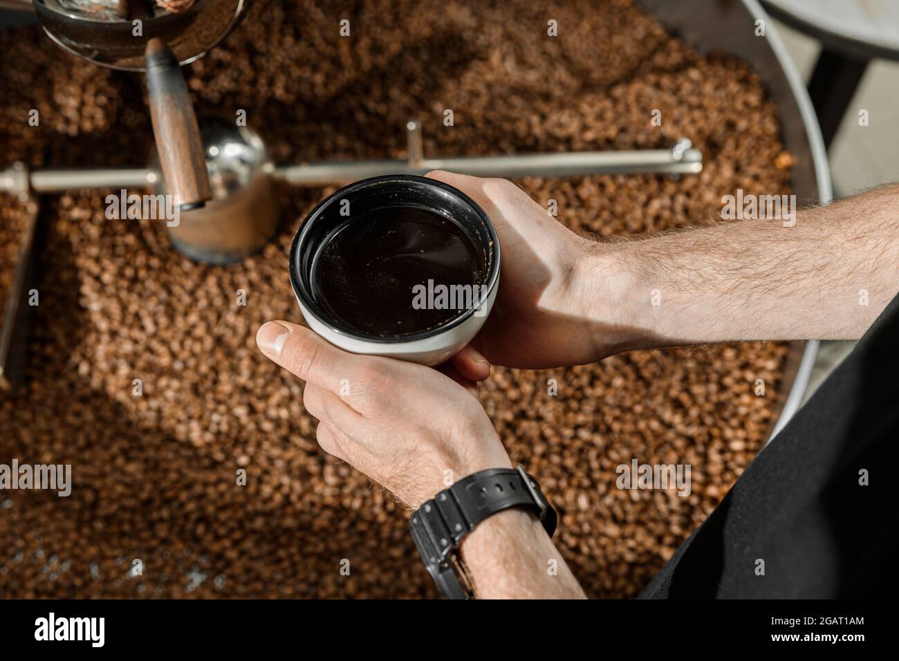 Coffee processing. Roastery, roasting machine and fresh beans Stock ...