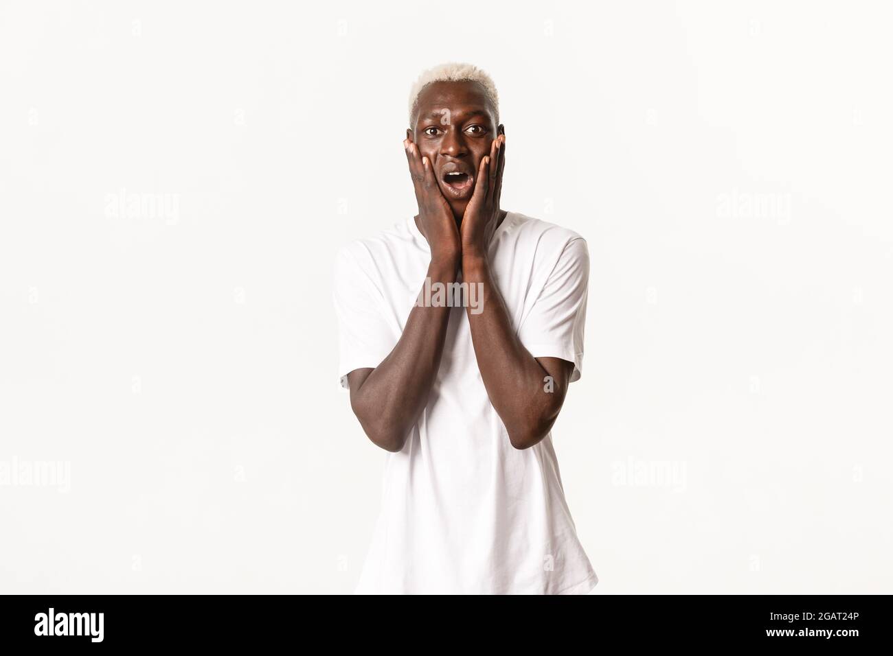 Portrait of surprised and excited african-american blond guy, gasping ...