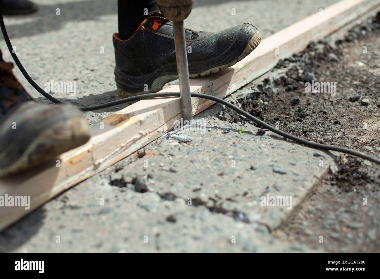 He removes the asphalt with a jackhammer. Removing the asphalt layer ...