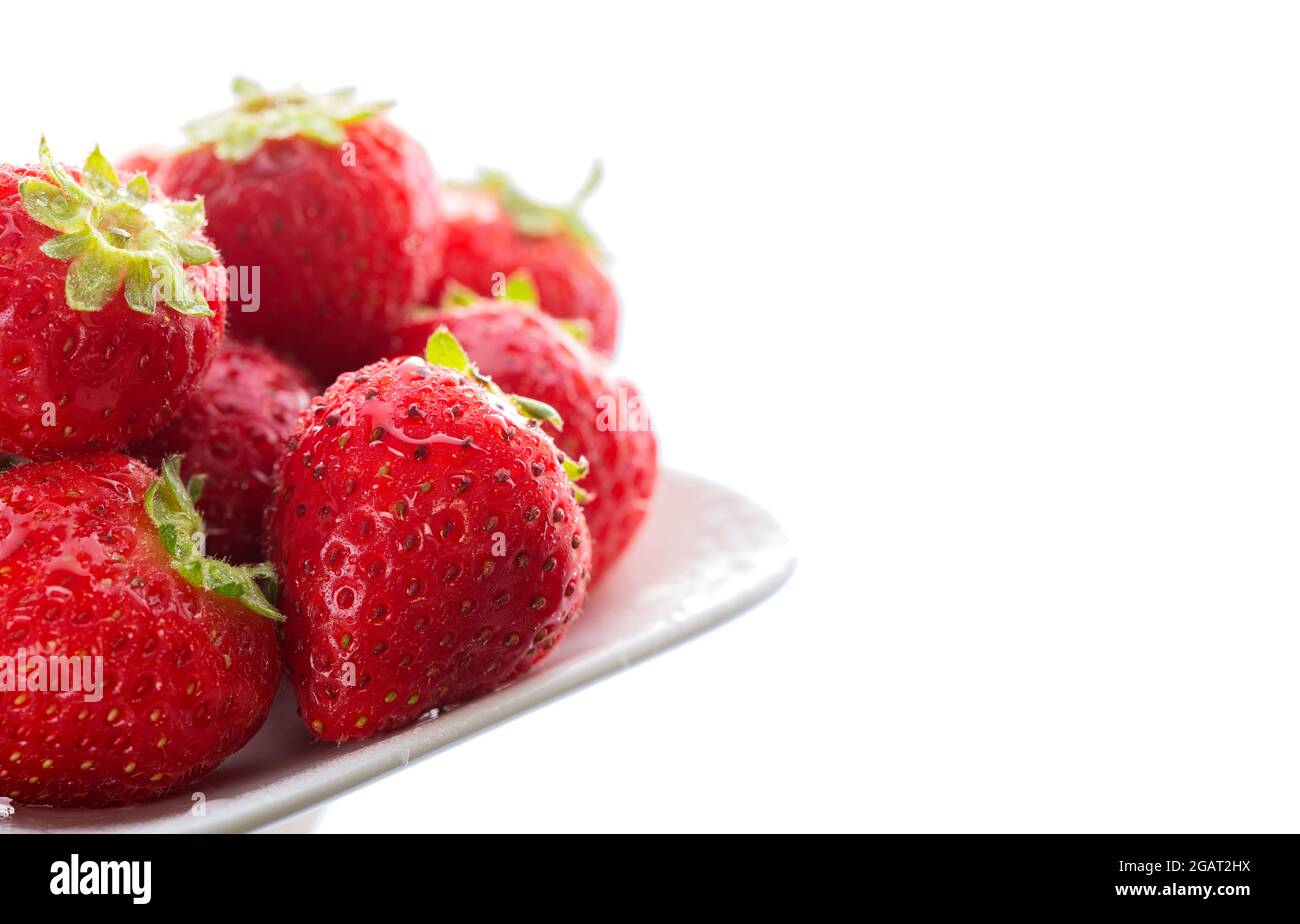 Plate full of strawberries with white copy space Stock Photo - Alamy