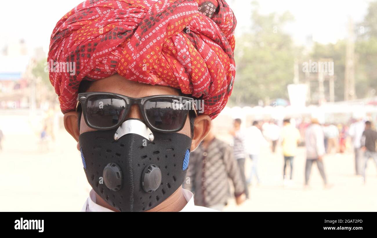 An Indian man wearing a respirator with a filter for running Stock ...
