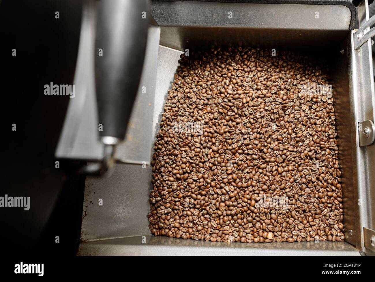 Coffee processing. Roastery, roasting machine and fresh beans Stock ...