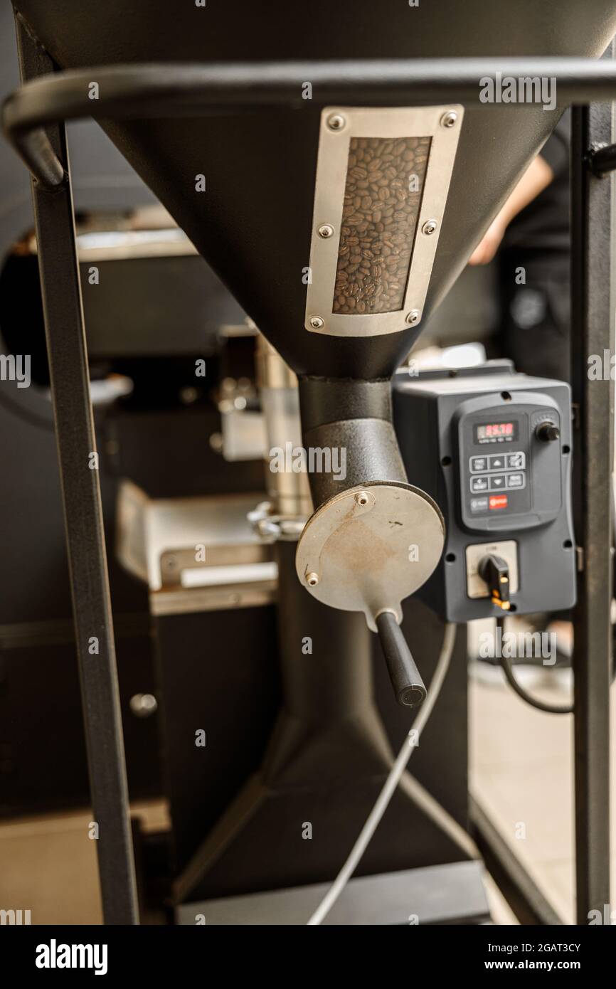 Coffee processing. Roastery, roasting machine and fresh beans Stock ...