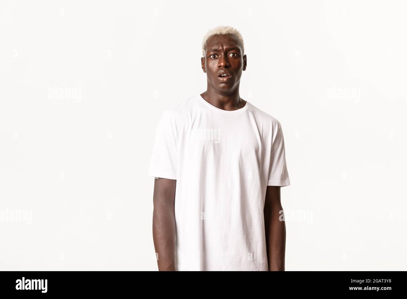 Portrait of startled and confused african-american blond man, open ...