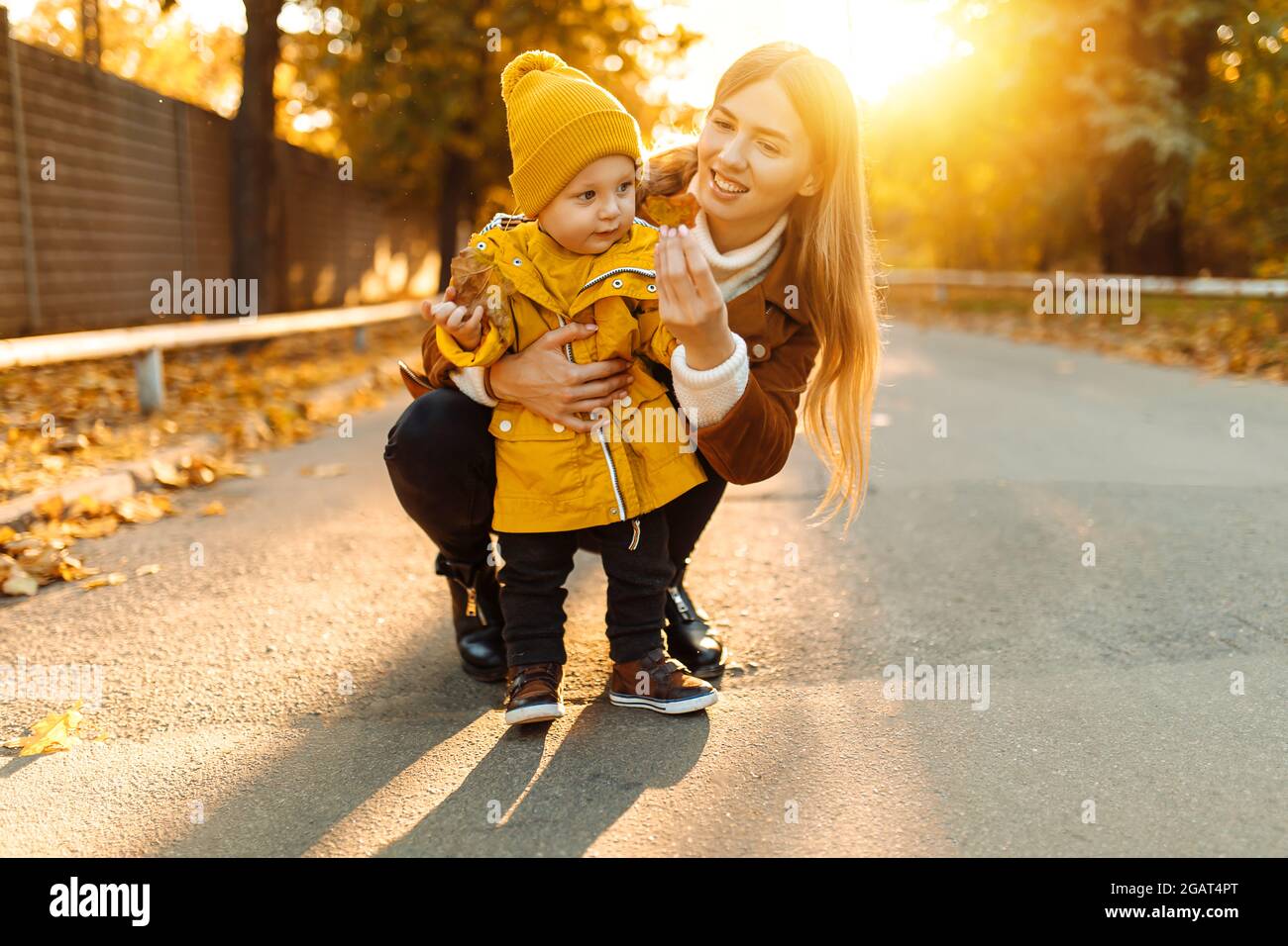 Happy family, mother and child play hugging on an autumn walk in nature ...