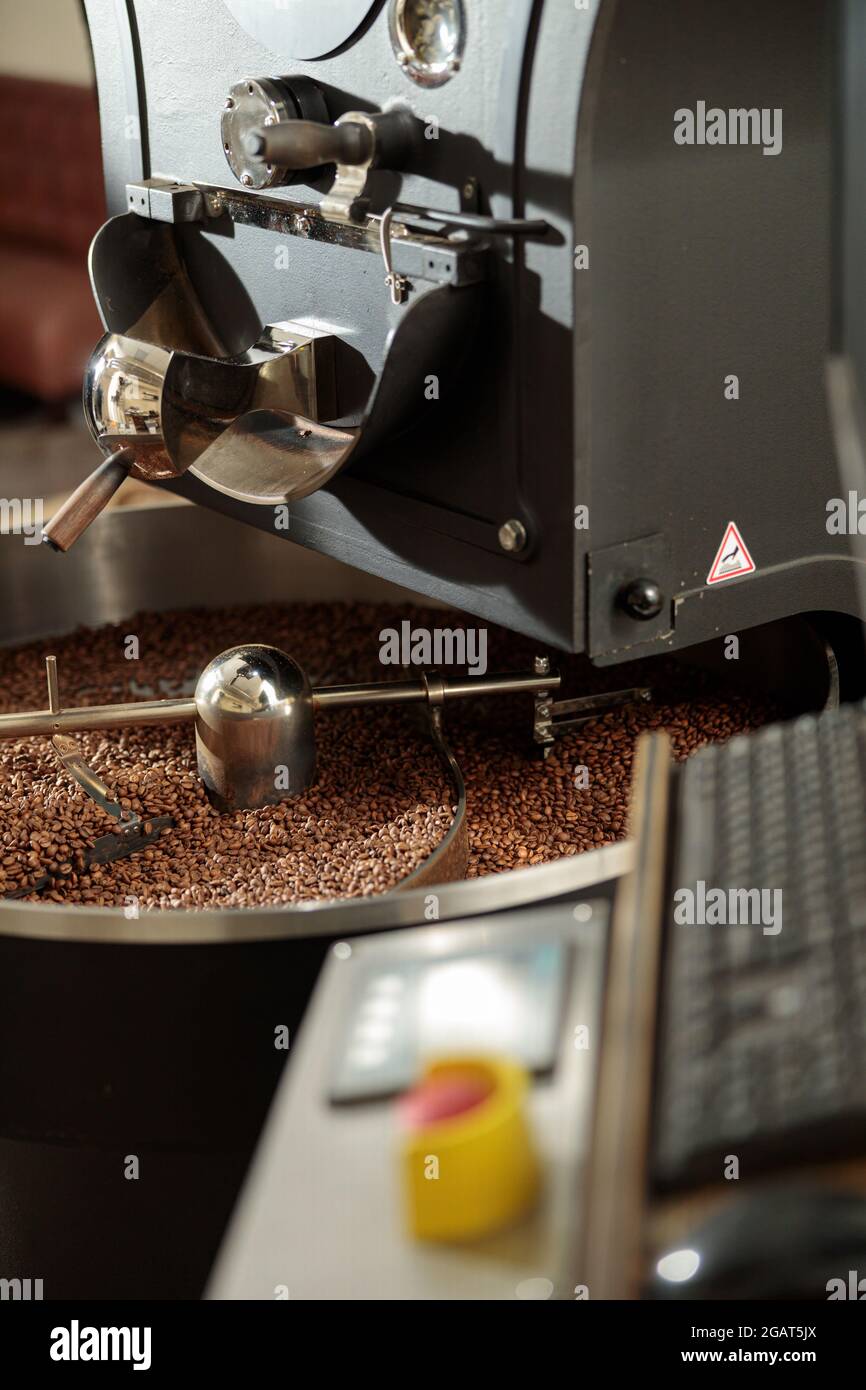 Coffee processing. Roastery, roasting machine and fresh beans Stock ...