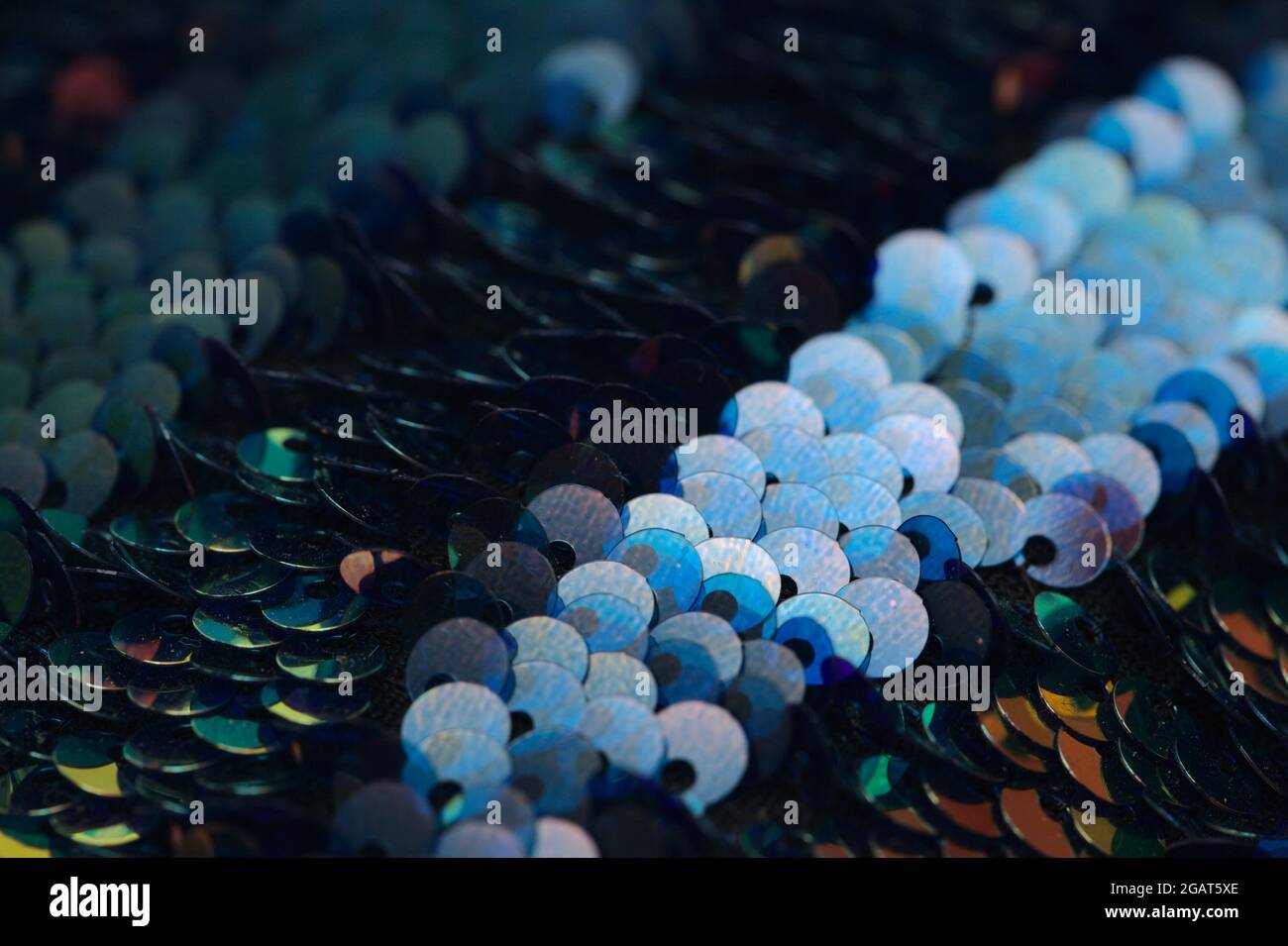 Macro background of two-sided sequined fabric with different angles of ...