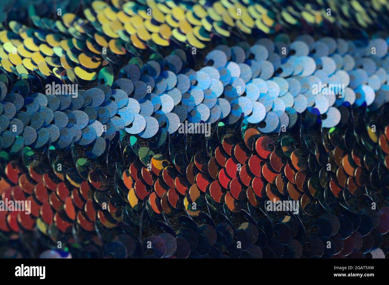 Macro background of two-sided sequined fabric with different angles of ...