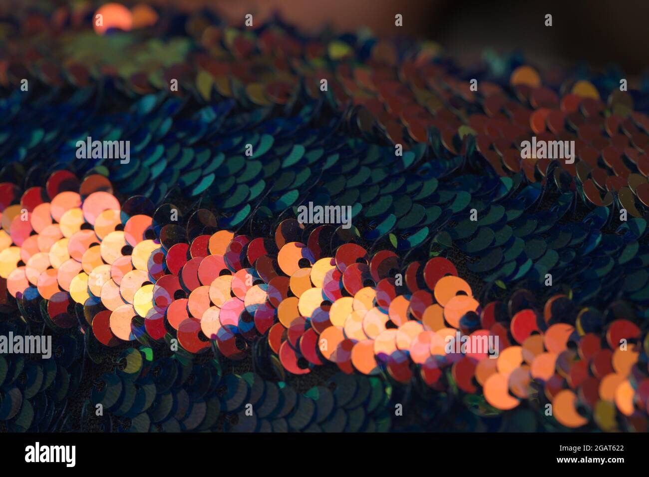 Macro background of two-sided sequined fabric with different angles of ...