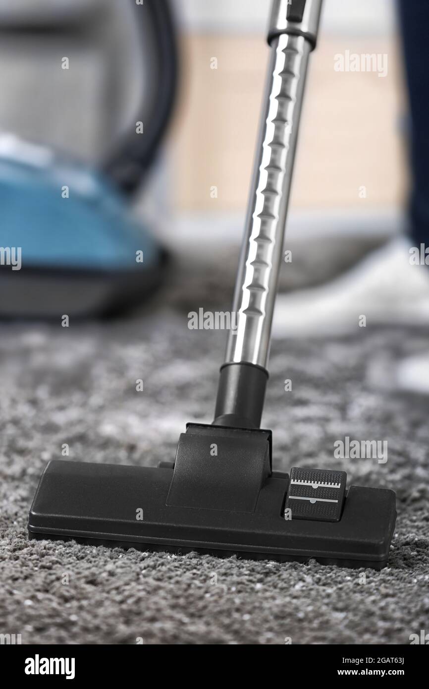 Cleaning concept - woman cleaning the room with carpet sweeper, close ...