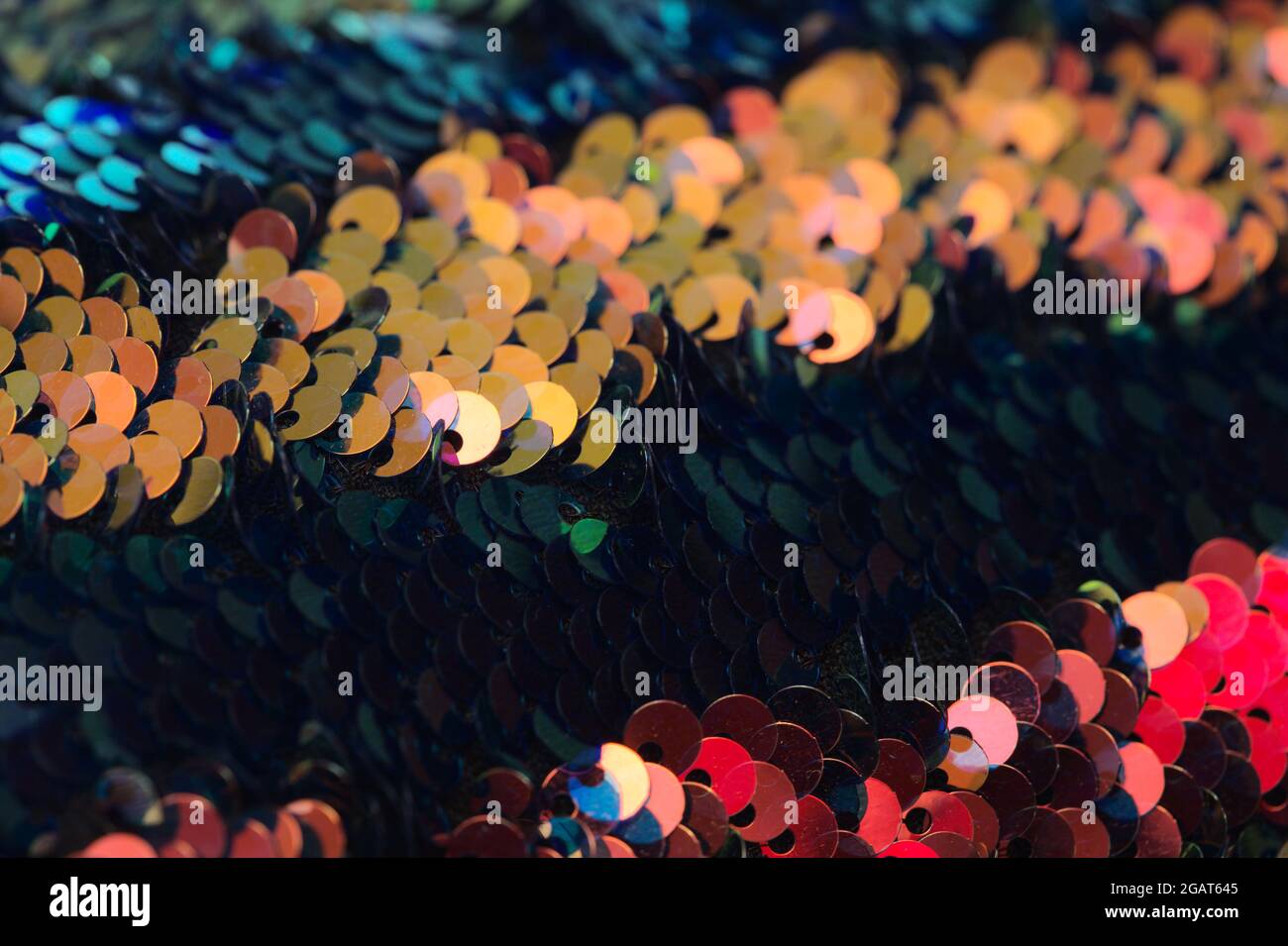 Macro background of two-sided sequined fabric with different angles of ...
