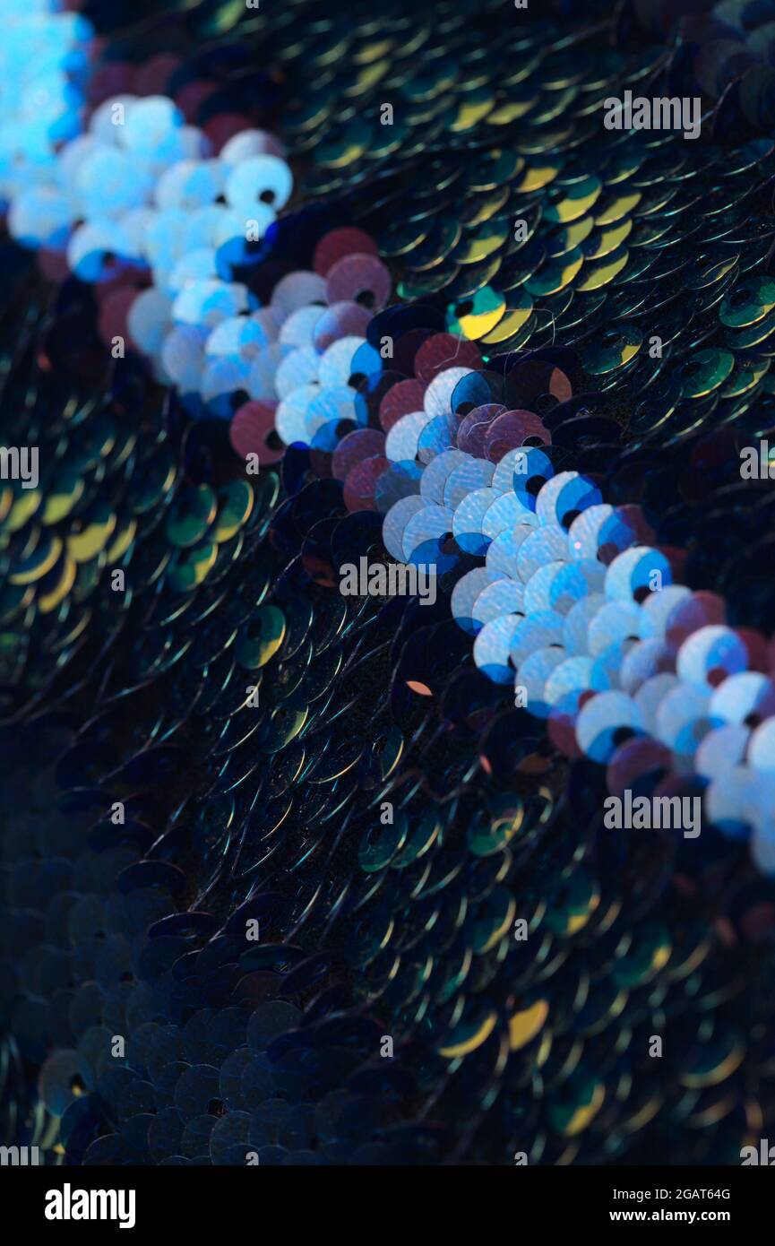 Macro background of two-sided sequined fabric with different angles of ...