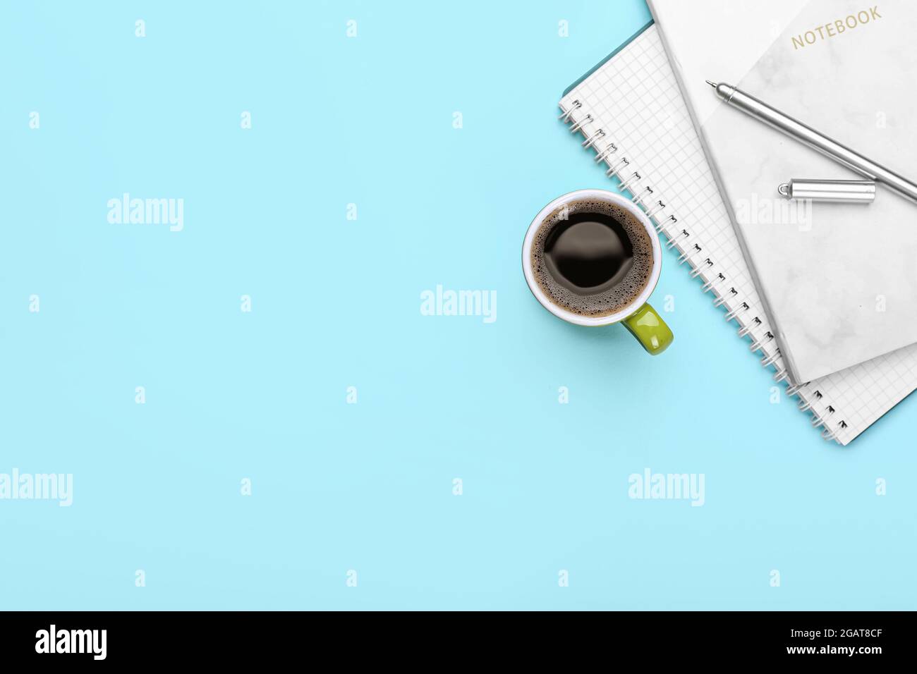Cup of coffee, notebooks and pen on color background Stock Photo - Alamy