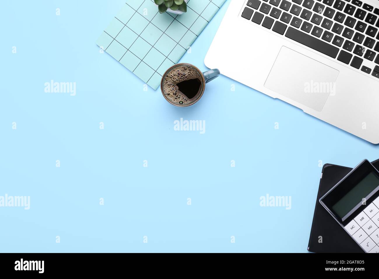 Cup of coffee, laptop, notebook and calculator on color background ...