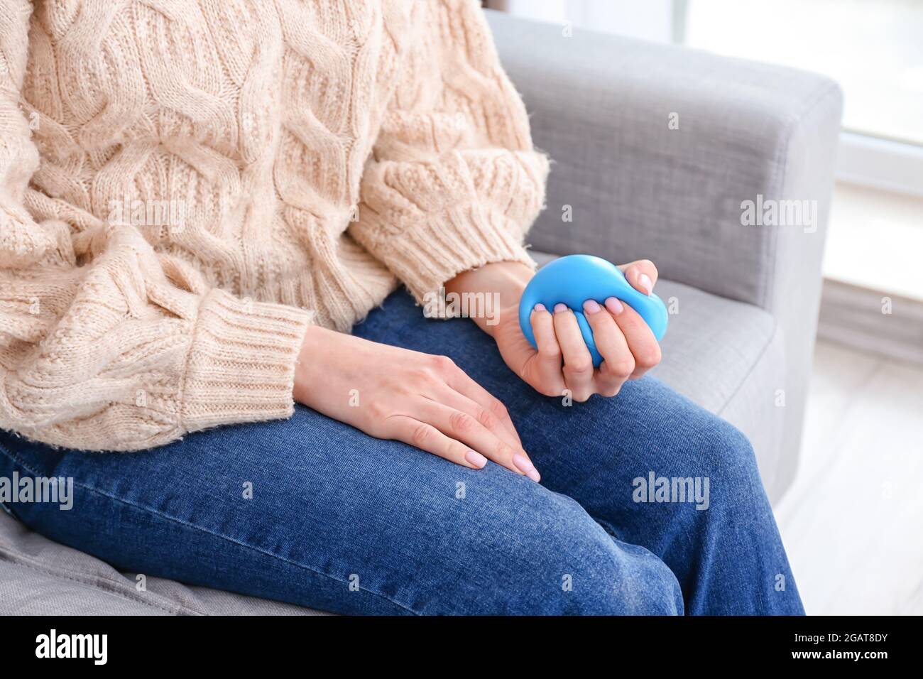 Woman squeezing stress ball, closeup Stock Photo - Alamy
