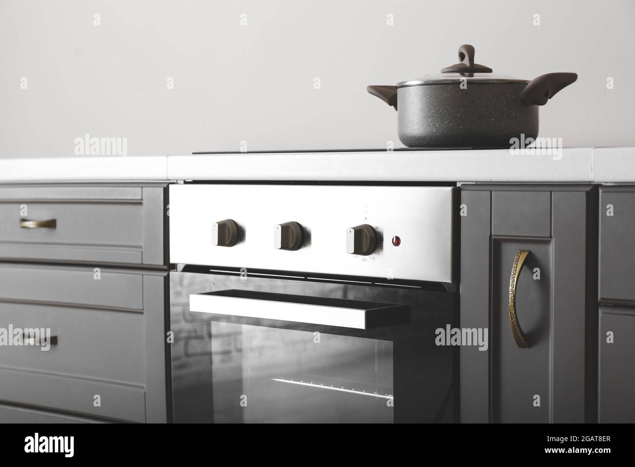 Modern kitchen counter with electric oven near light wall Stock Photo ...