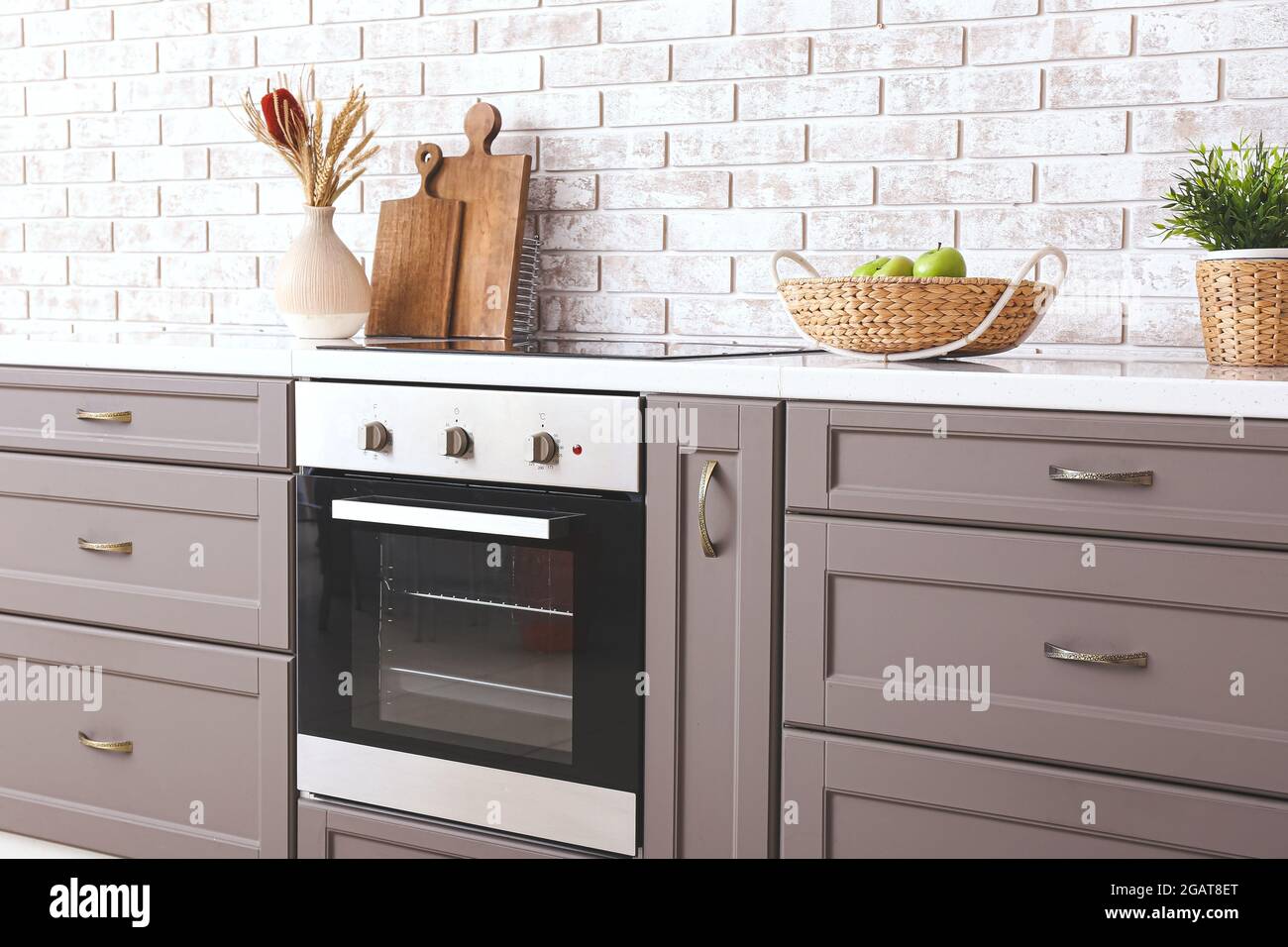Modern kitchen counter with electric oven near brick wall Stock Photo ...