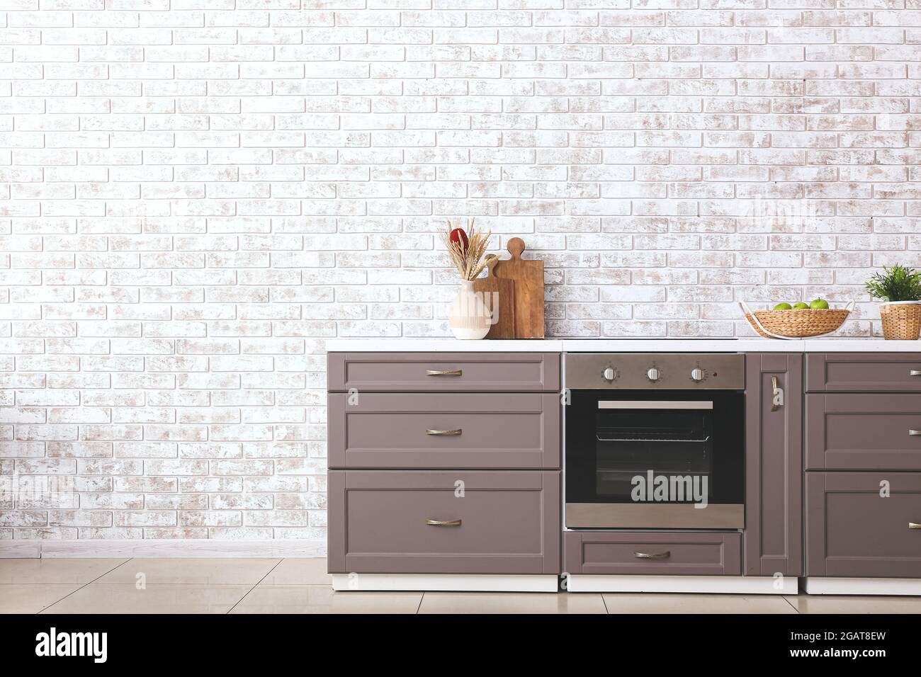 Modern kitchen counter with electric oven near brick wall Stock Photo ...