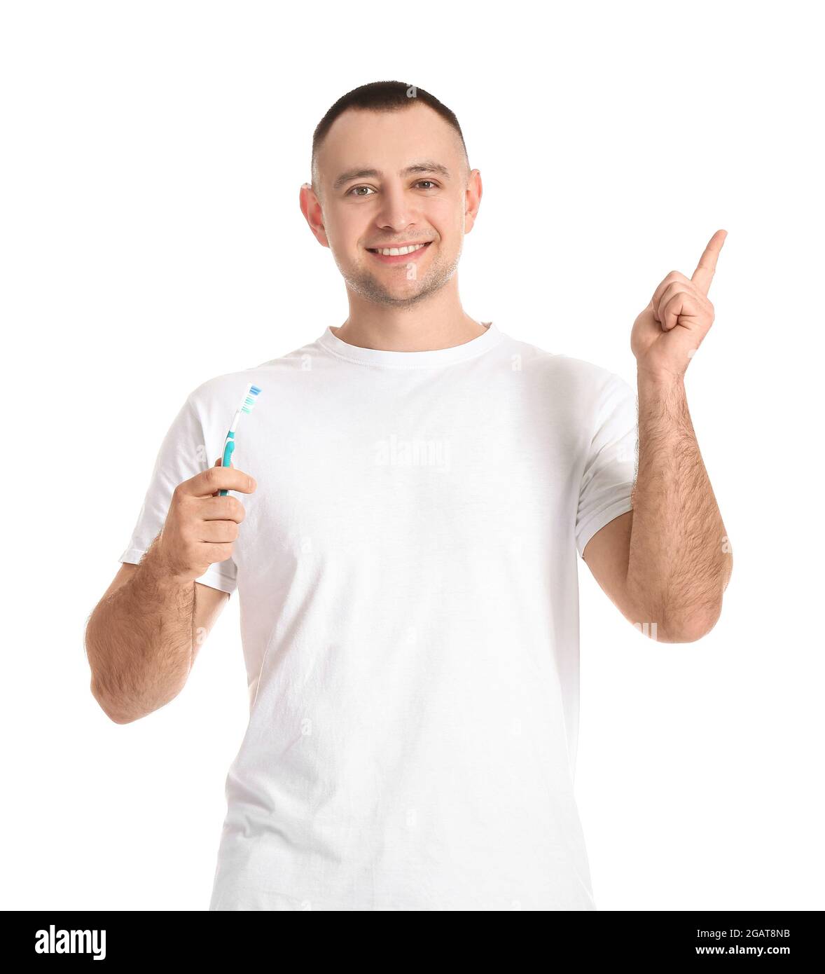 Man with tooth brush pointing at something on white background Stock ...