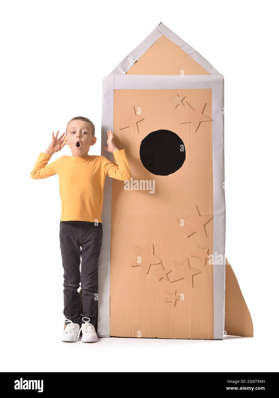 Shocked little boy with cardboard rocket on white background Stock ...