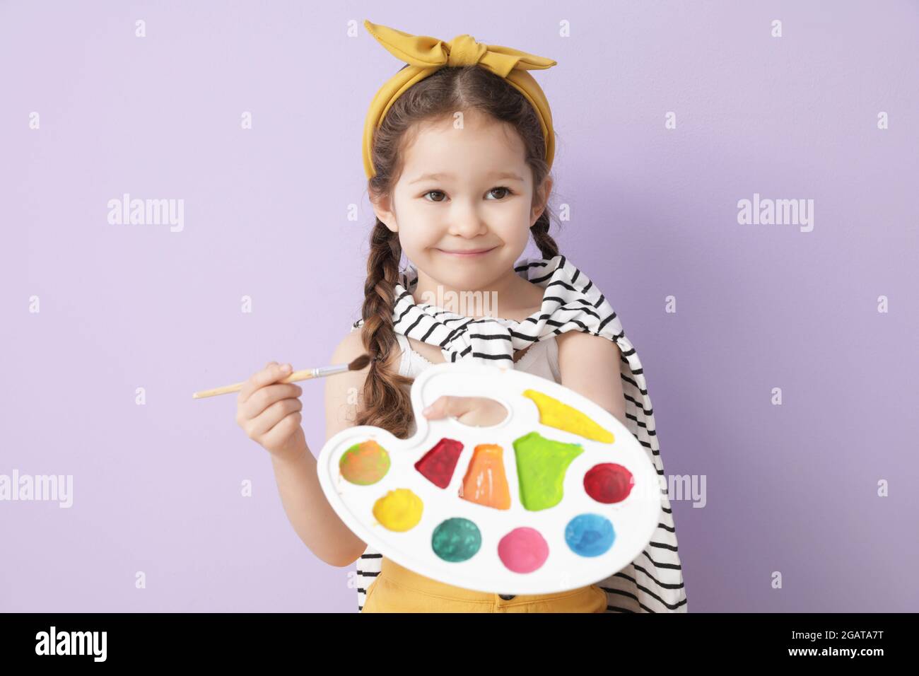 Cute little artist on color background Stock Photo - Alamy