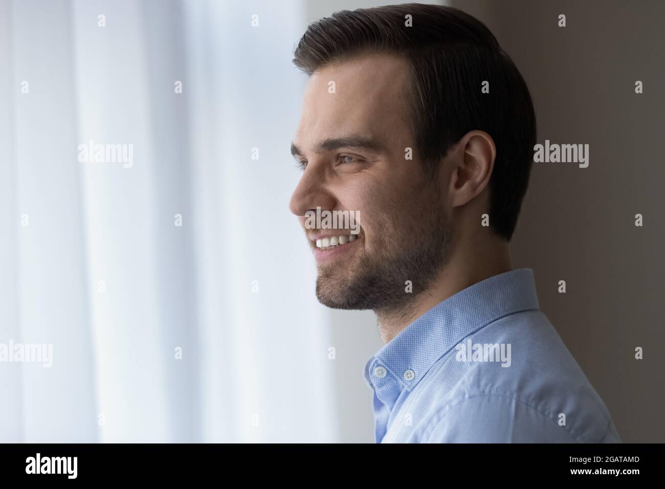 Businessman standing window looking distance hi-res stock photography ...