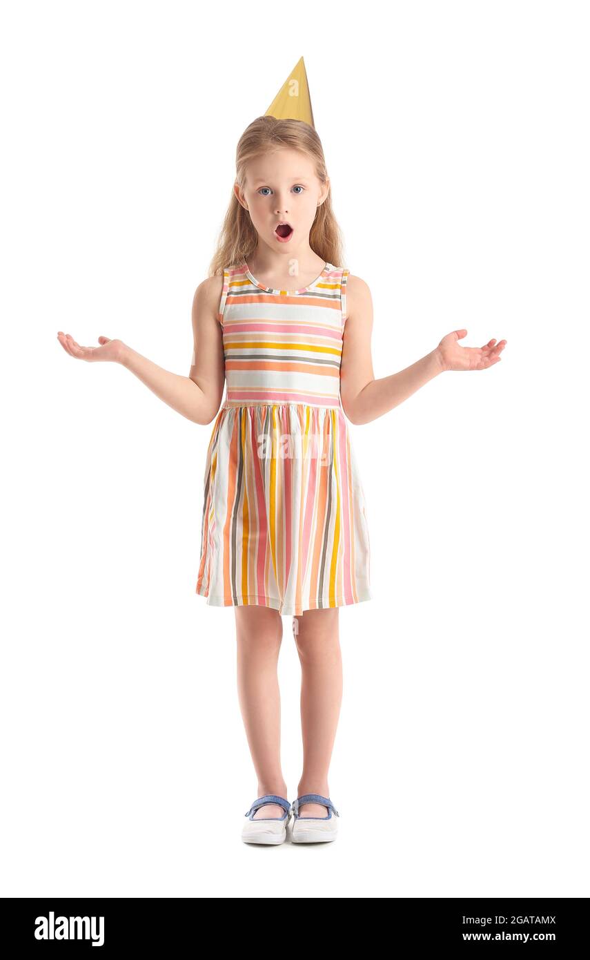 Surprised little girl in party hat on white background Stock Photo - Alamy