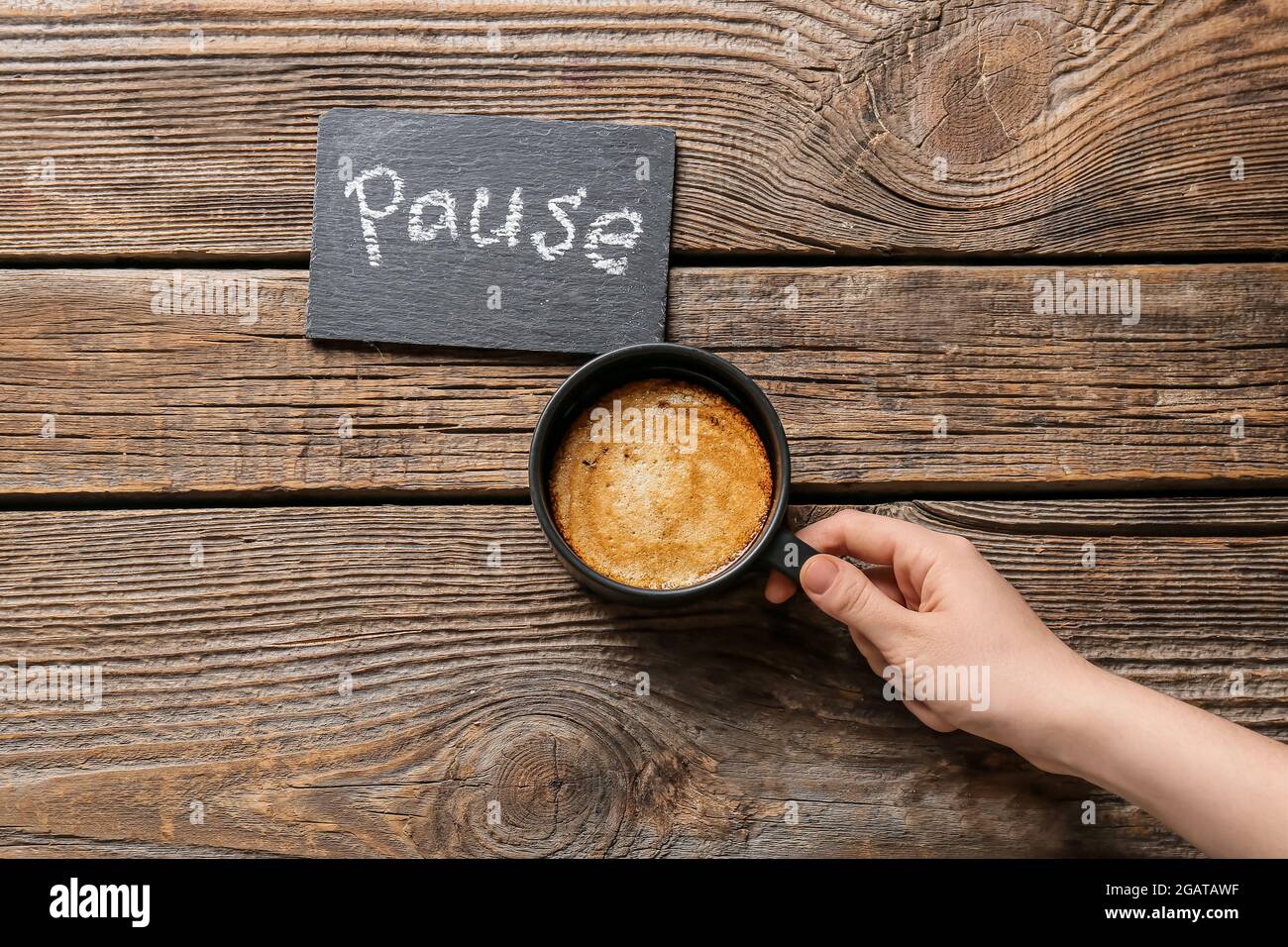 Woman with cup of coffee and word PAUSE on wooden background Stock ...