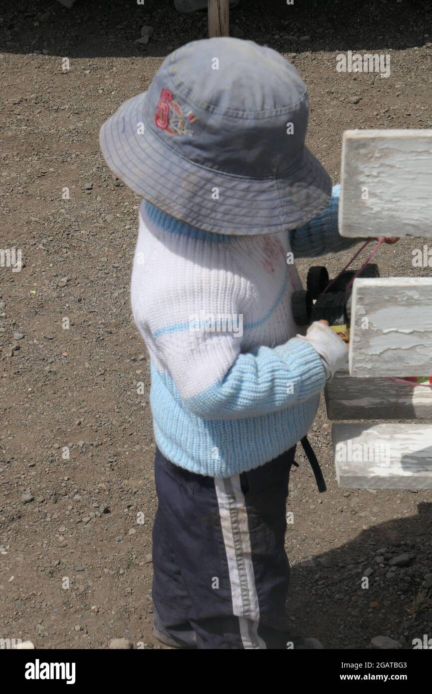 Child with sun hat in Peru baby standing stand playing play outside ...